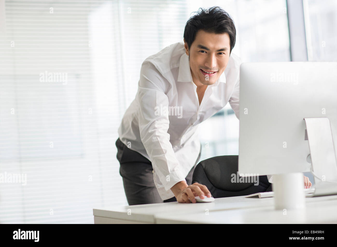Young businessman using computer in office Stock Photo - Alamy