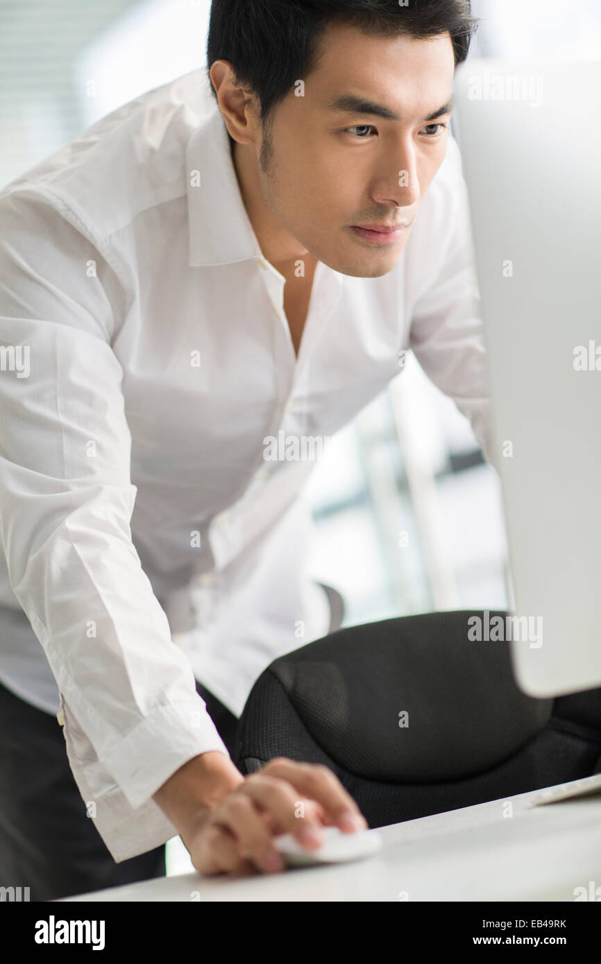 Young businessman using computer in office Stock Photo - Alamy
