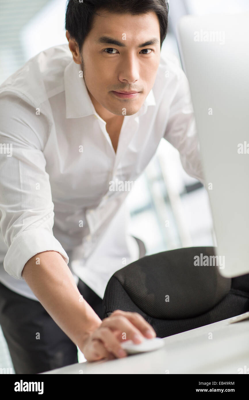 Young businessman using computer in office Stock Photo - Alamy