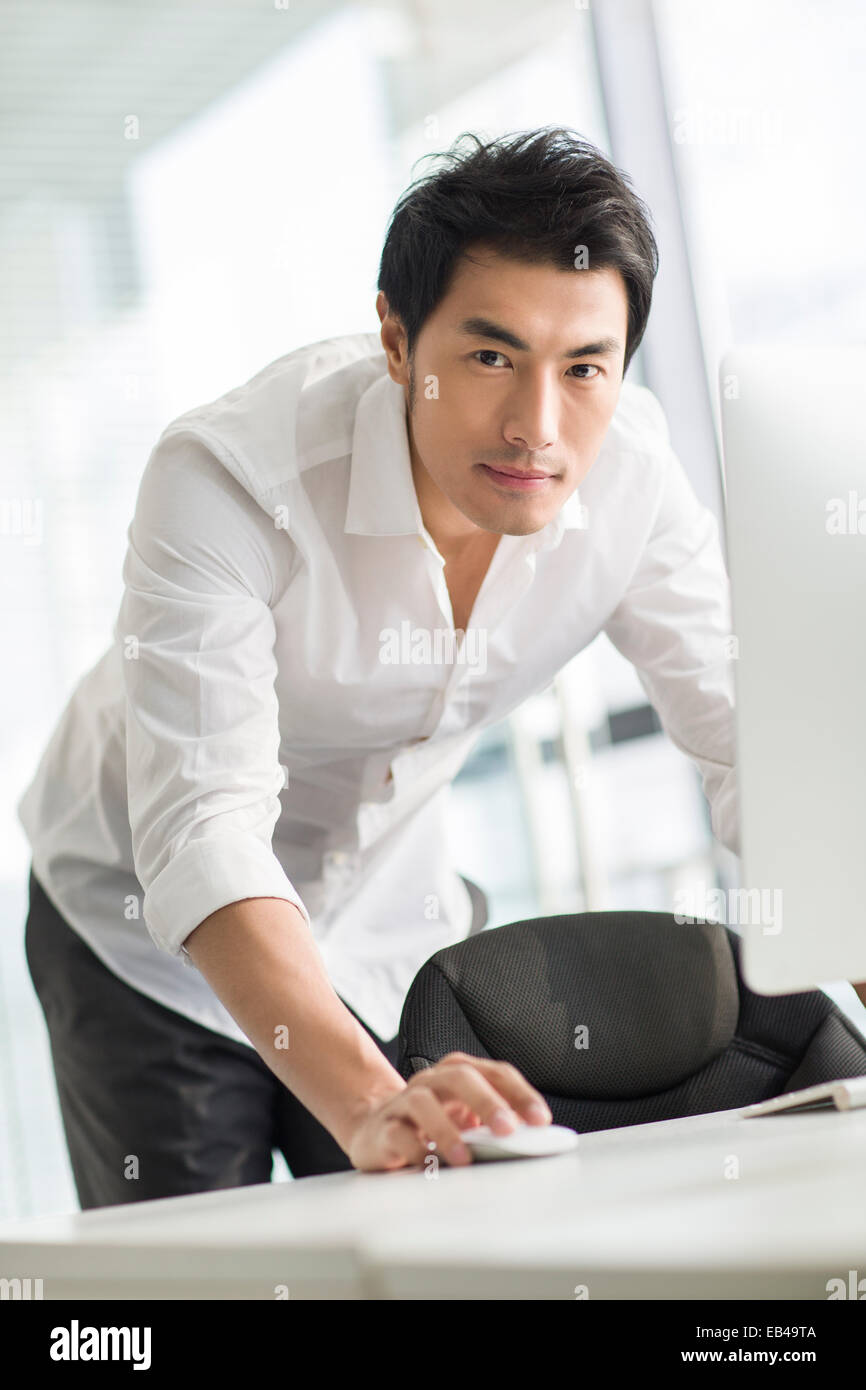 Young businessman using computer in office Stock Photo - Alamy