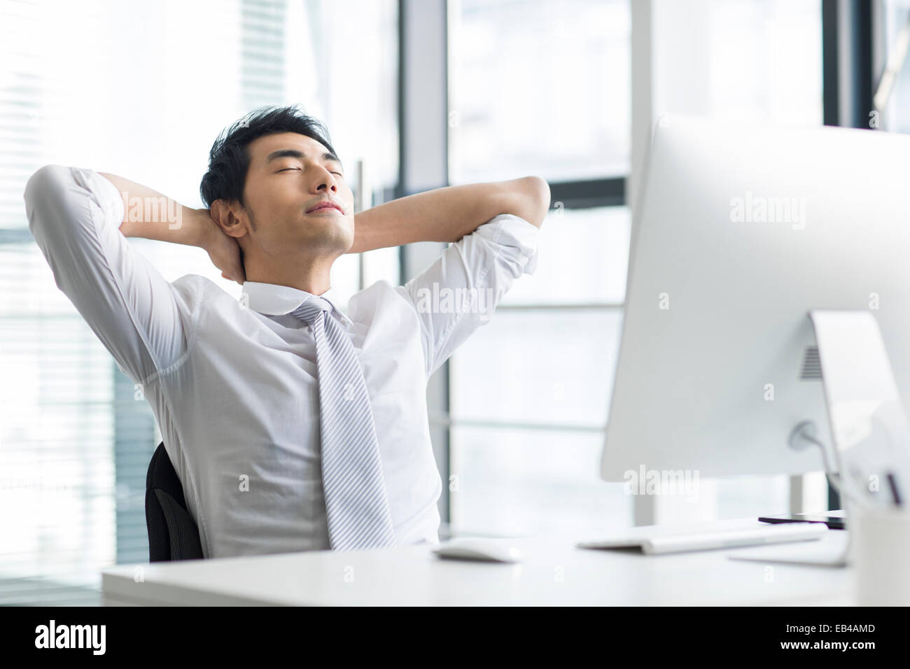 Young businessman resting in office Stock Photo - Alamy