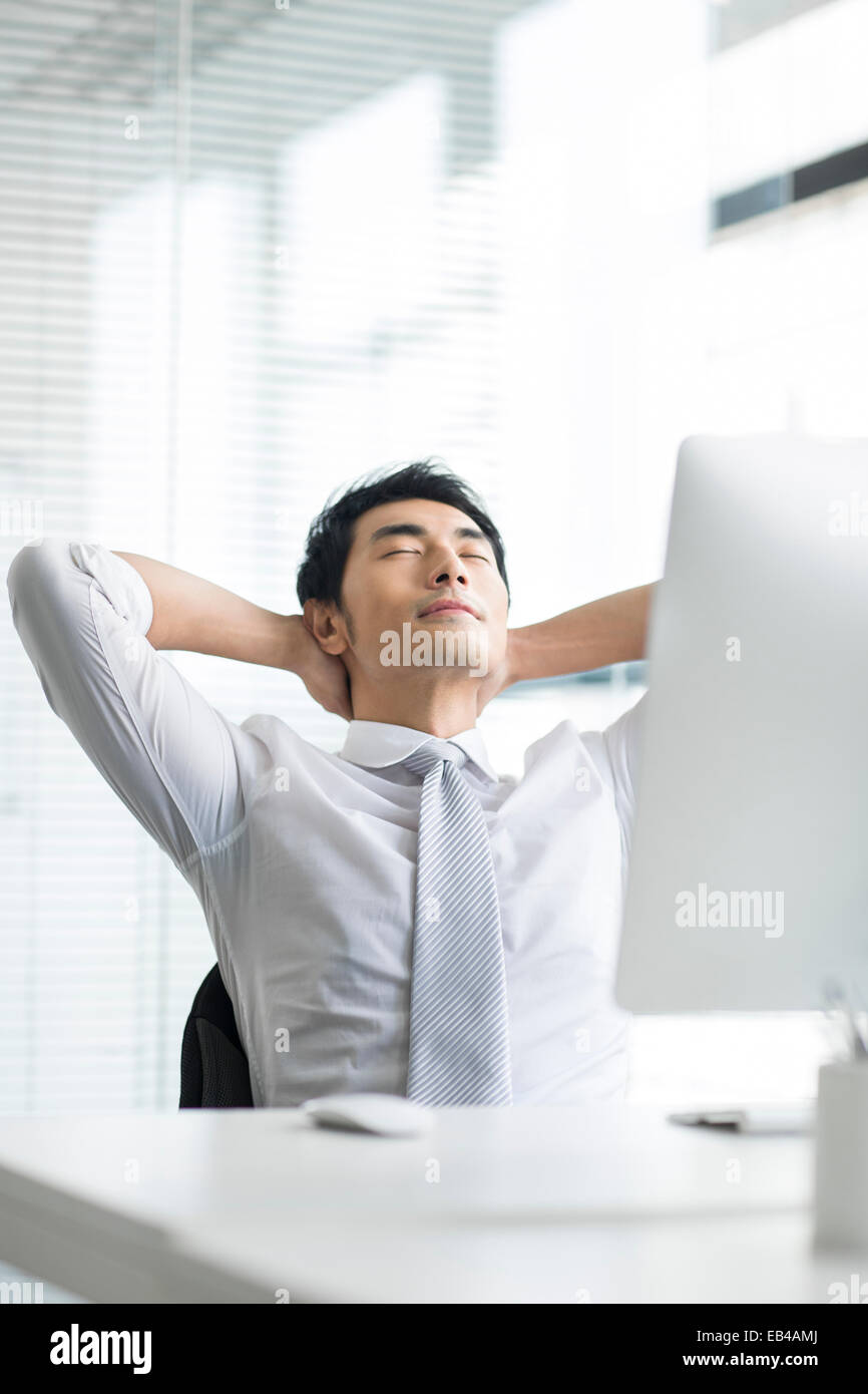 Young businessman resting in office Stock Photo - Alamy