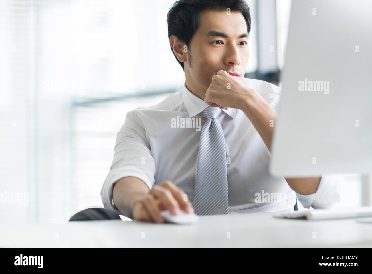 Young businessman using computer in office Stock Photo - Alamy