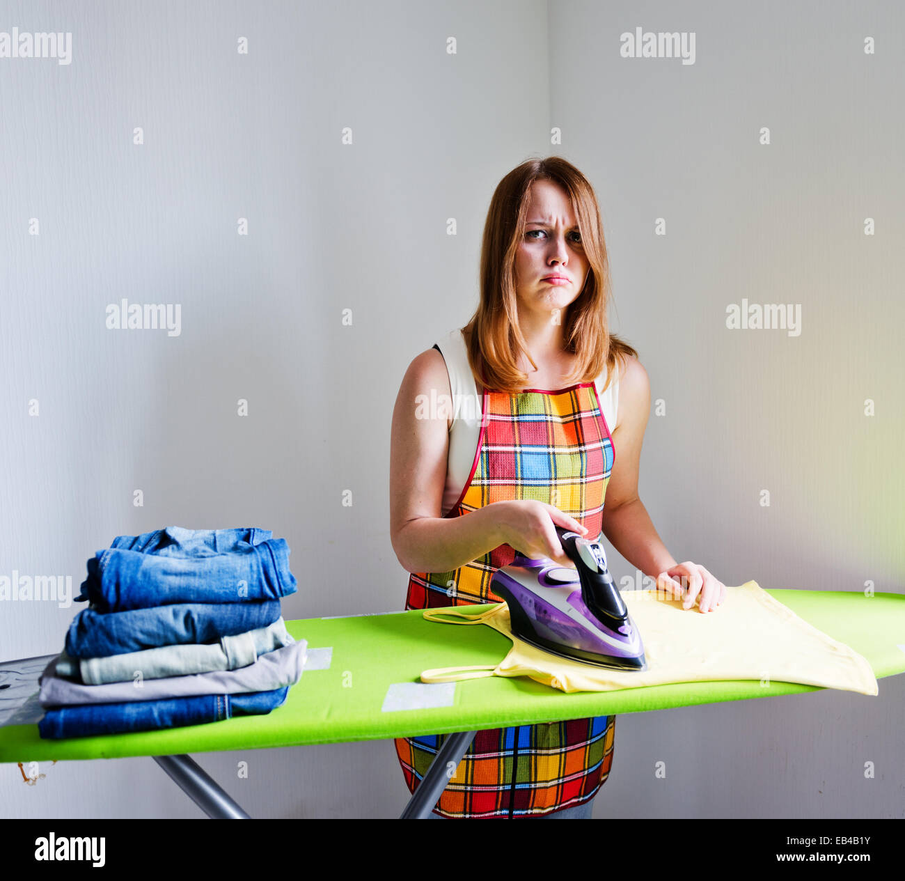 sad woman of doing the ironing. Housework Stock Photo - Alamy