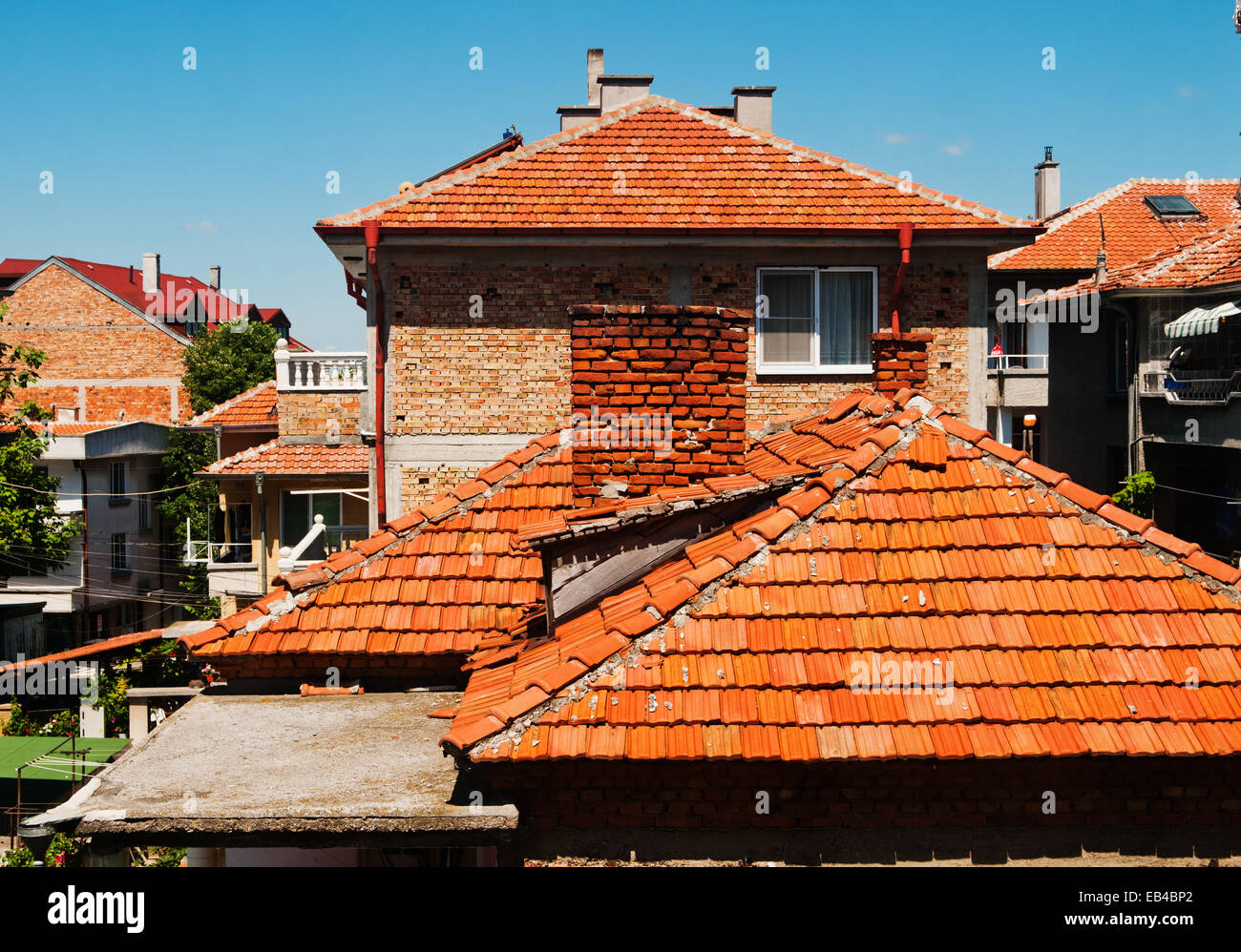 Red rooftops of old residential houses with view in their backyards ...