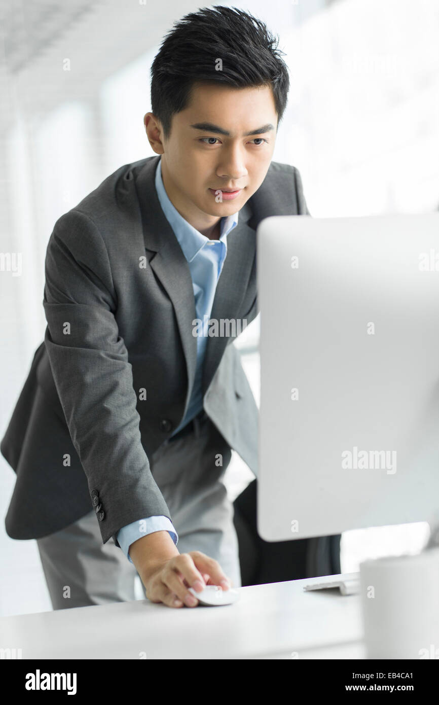 Young businessman using computer in office Stock Photo - Alamy