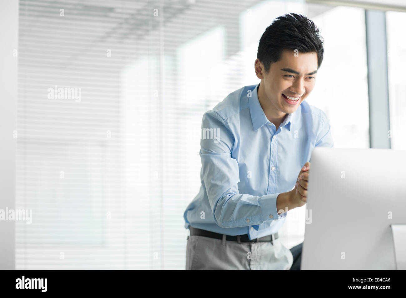 Young businessman using computer in office Stock Photo - Alamy