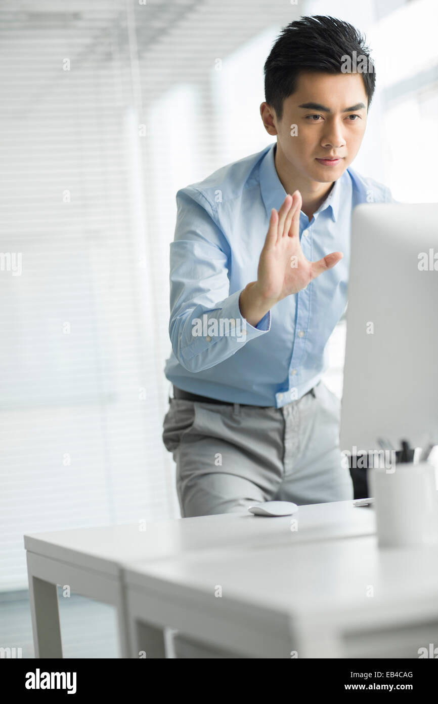Young businessman using computer in office Stock Photo - Alamy