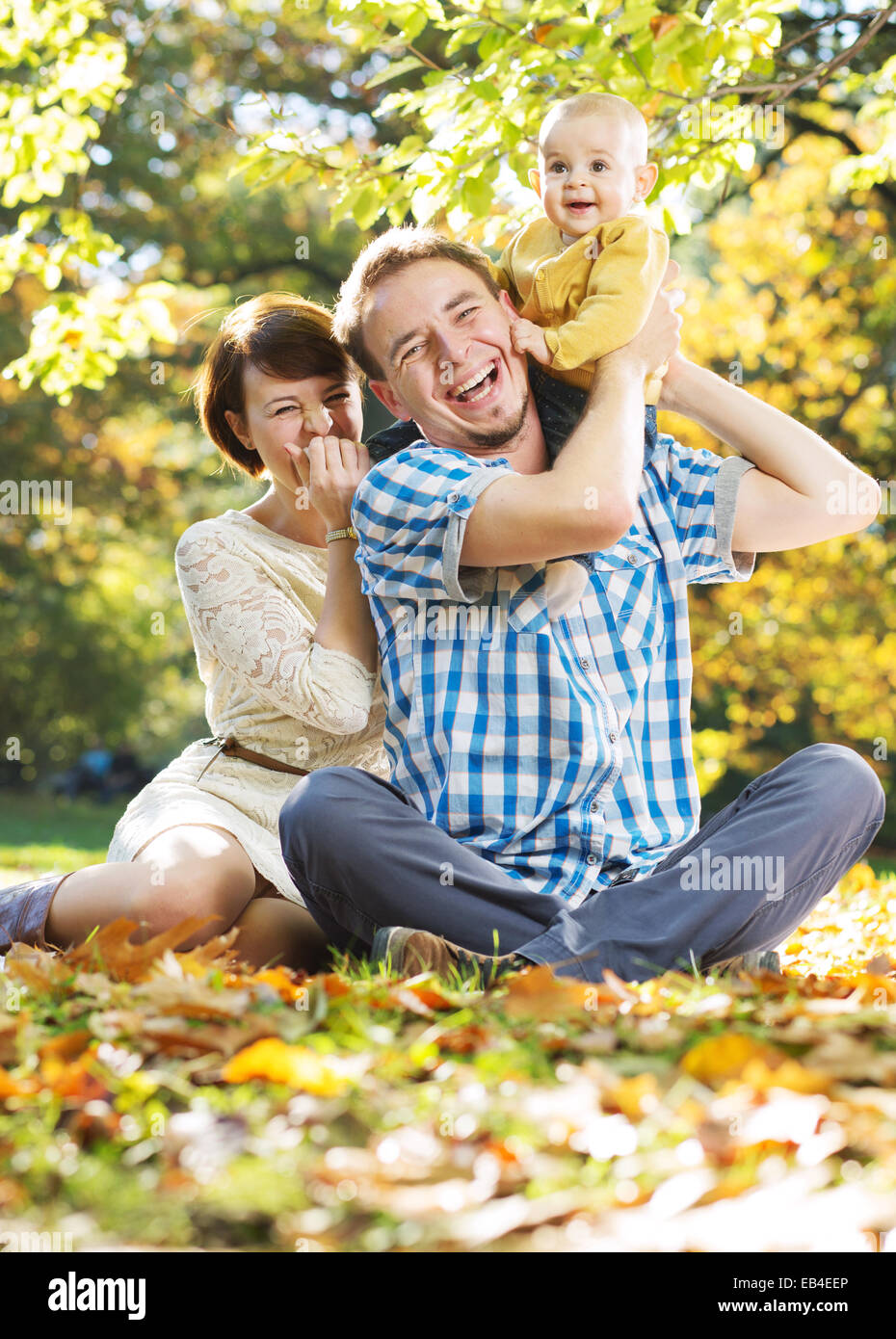 Laughing parents and their cute kid Stock Photo - Alamy