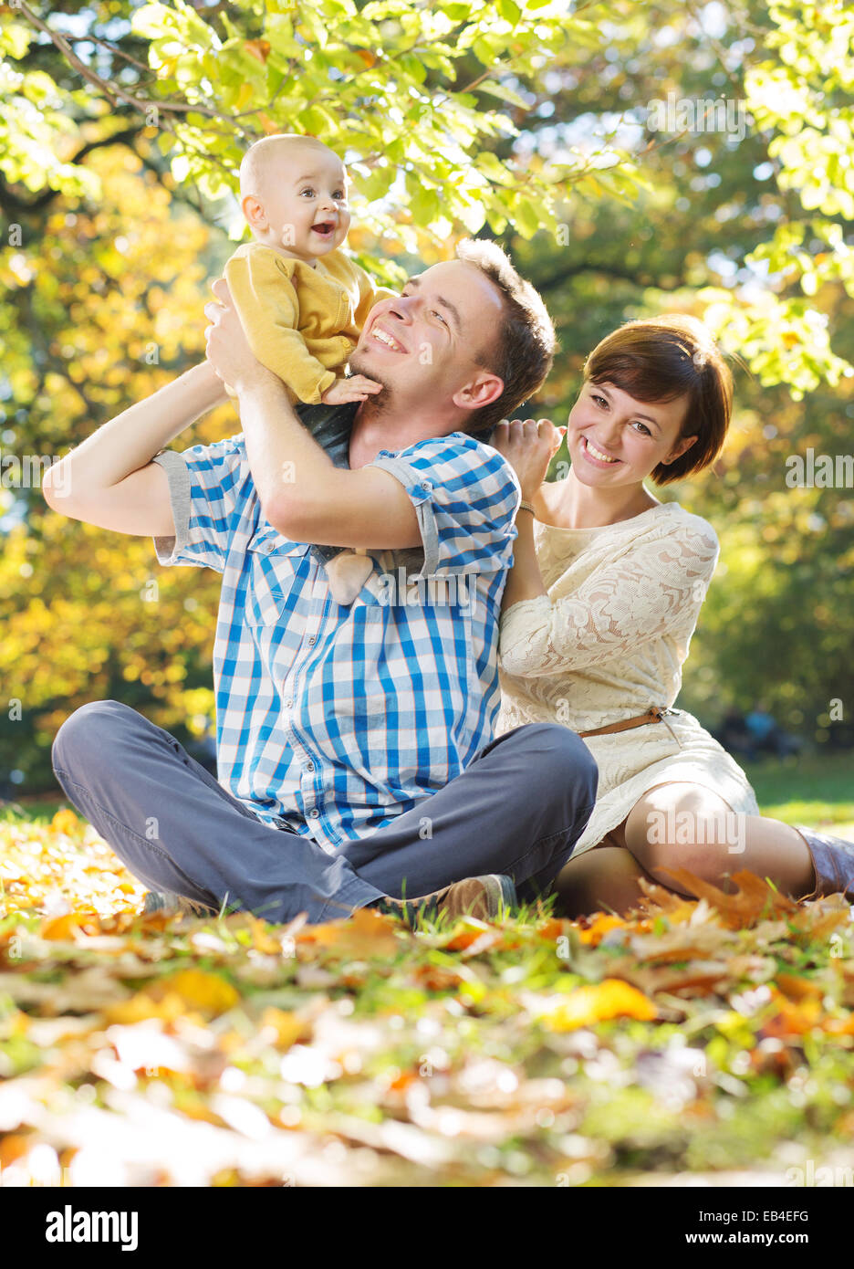 Young parents enjoying spare time with child Stock Photo - Alamy