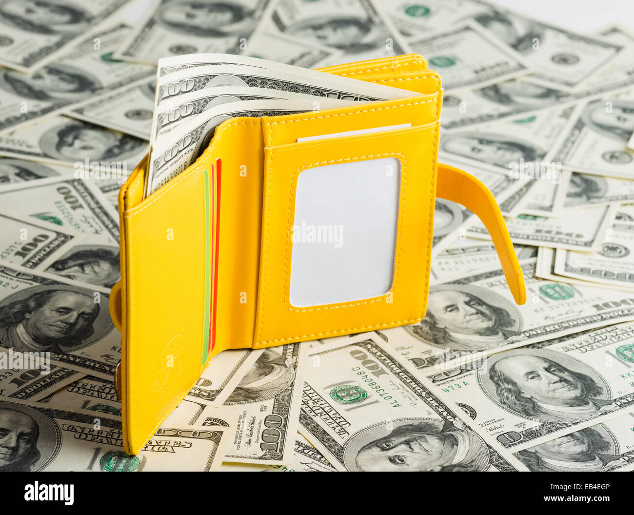 yellow Wallet Resting Upon Many United States One Hundred Dollar Notes ...