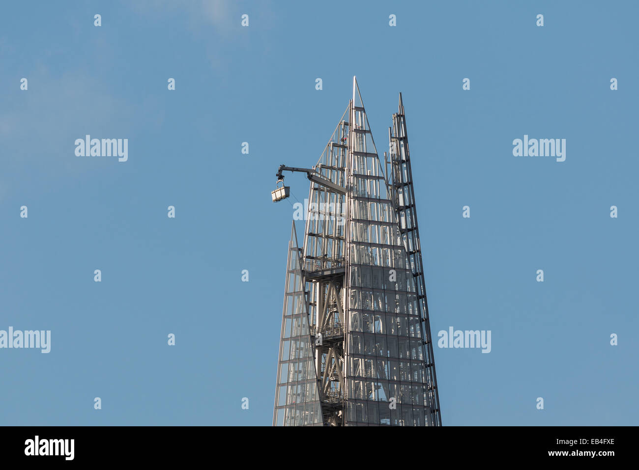 Workman's cradle hanging over the top of the Shard, London Stock Photo ...