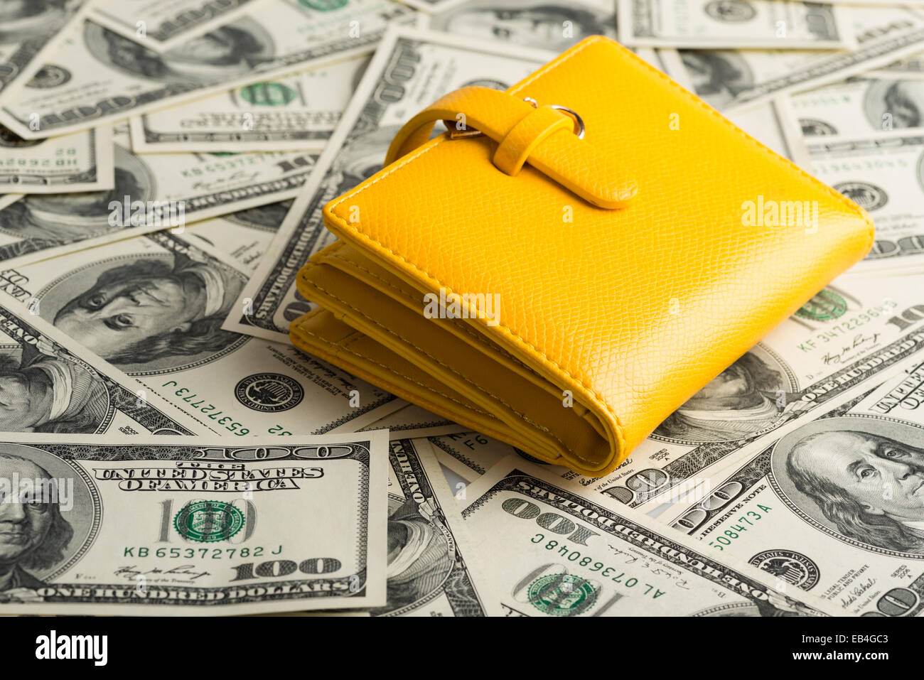 yellow Wallet Resting Upon Many United States One Hundred Dollar Notes ...