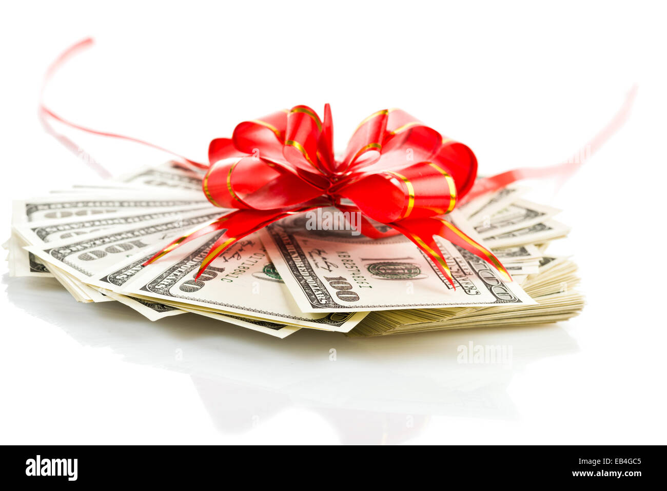 Money gift (big stack of dollars with red bow isolated on white ...
