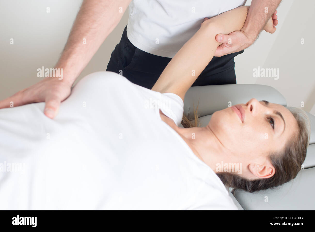 Doctor applying arm manipulation on a female patient Stock Photo - Alamy