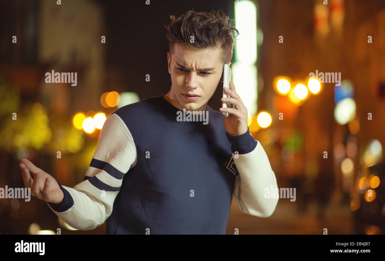 Calm young guy talking on the phone Stock Photo - Alamy