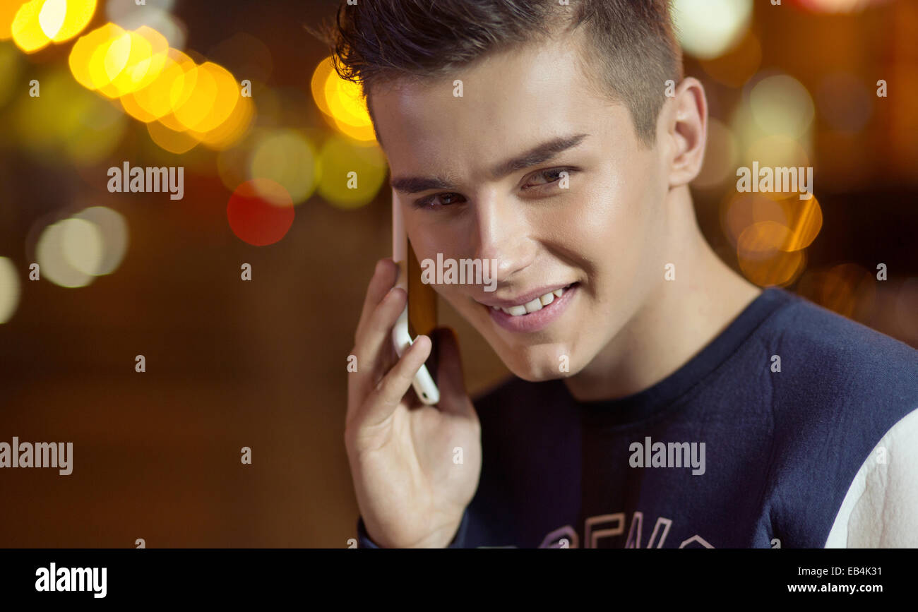 Young charming guy talking on the phone Stock Photo - Alamy