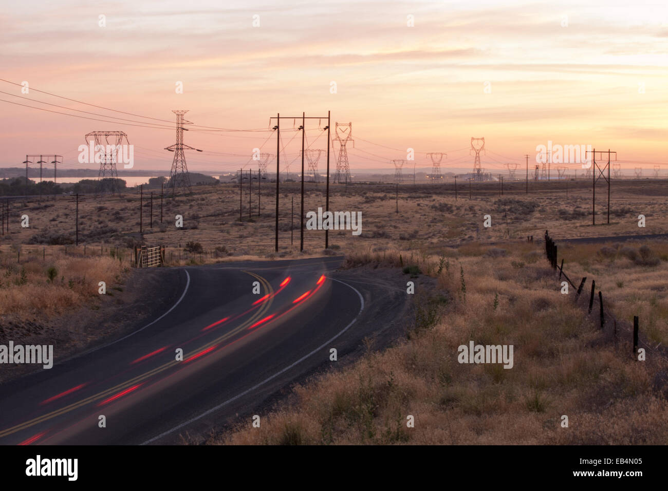Flashing taillights along a winding road under electrical power lines ...