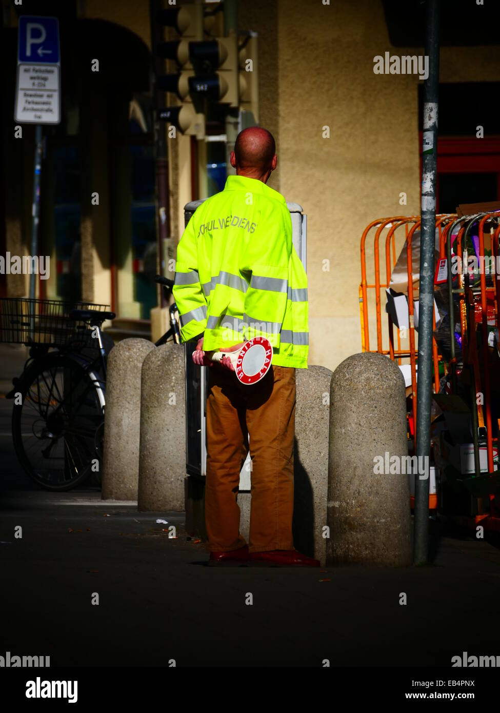 Lollipop School assistant with reflective jacket control traffic at ...