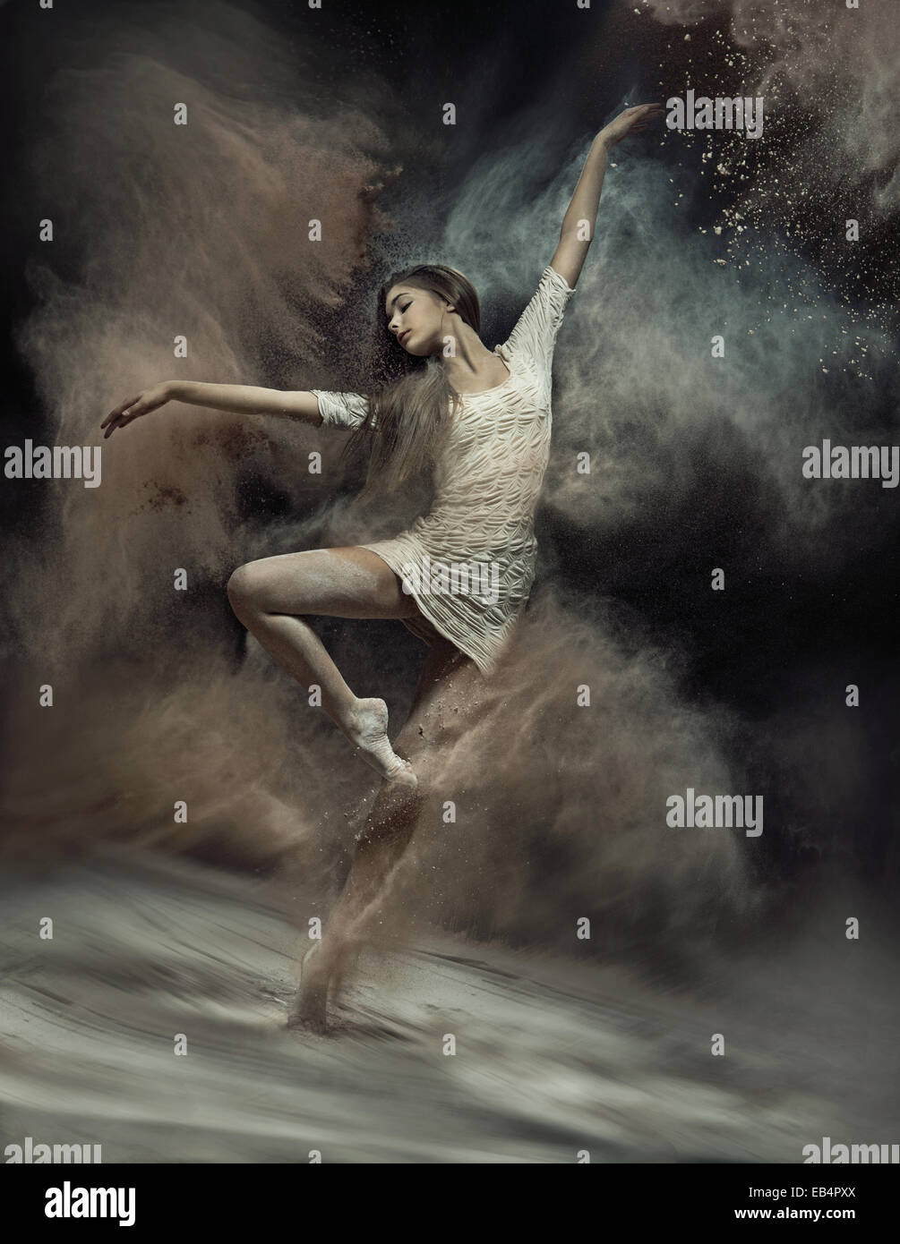 Pretty ballet dancer with dust in the background Stock Photo - Alamy