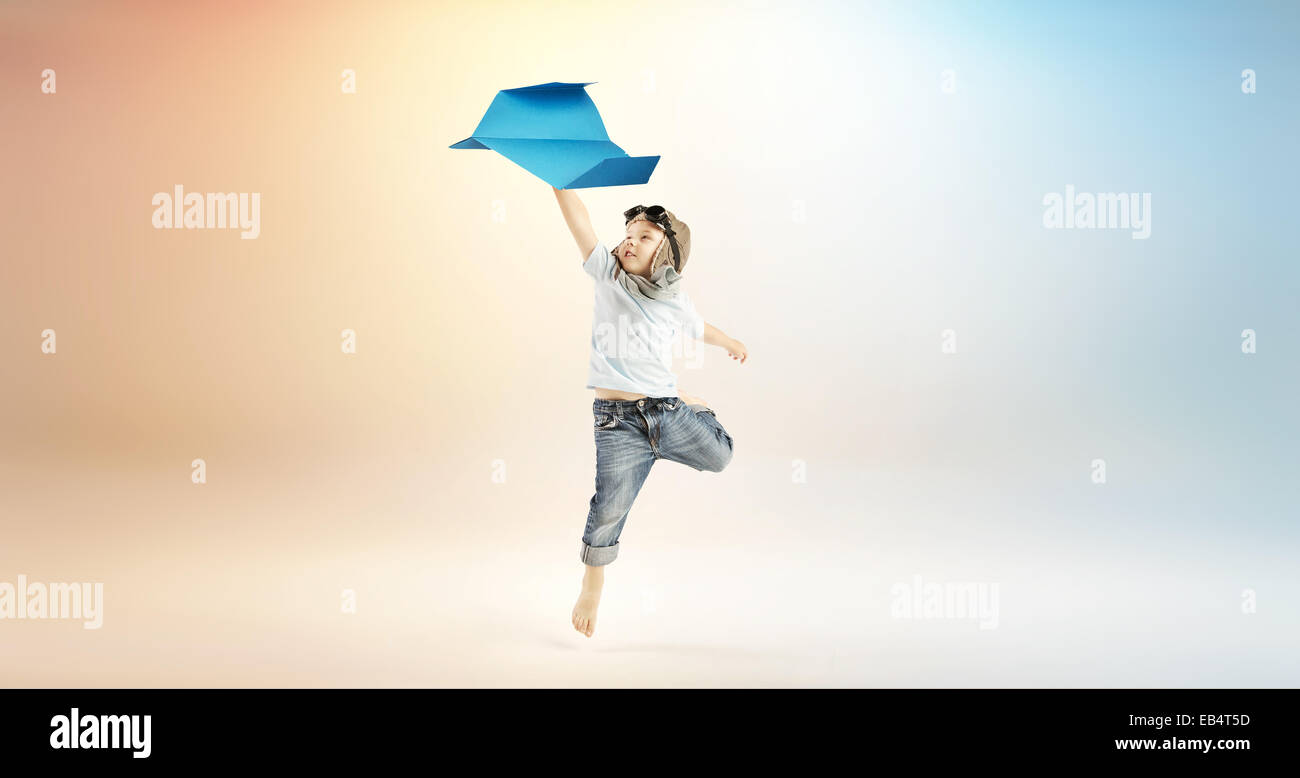 Cute little boy flying with the paper toy plane Stock Photo - Alamy