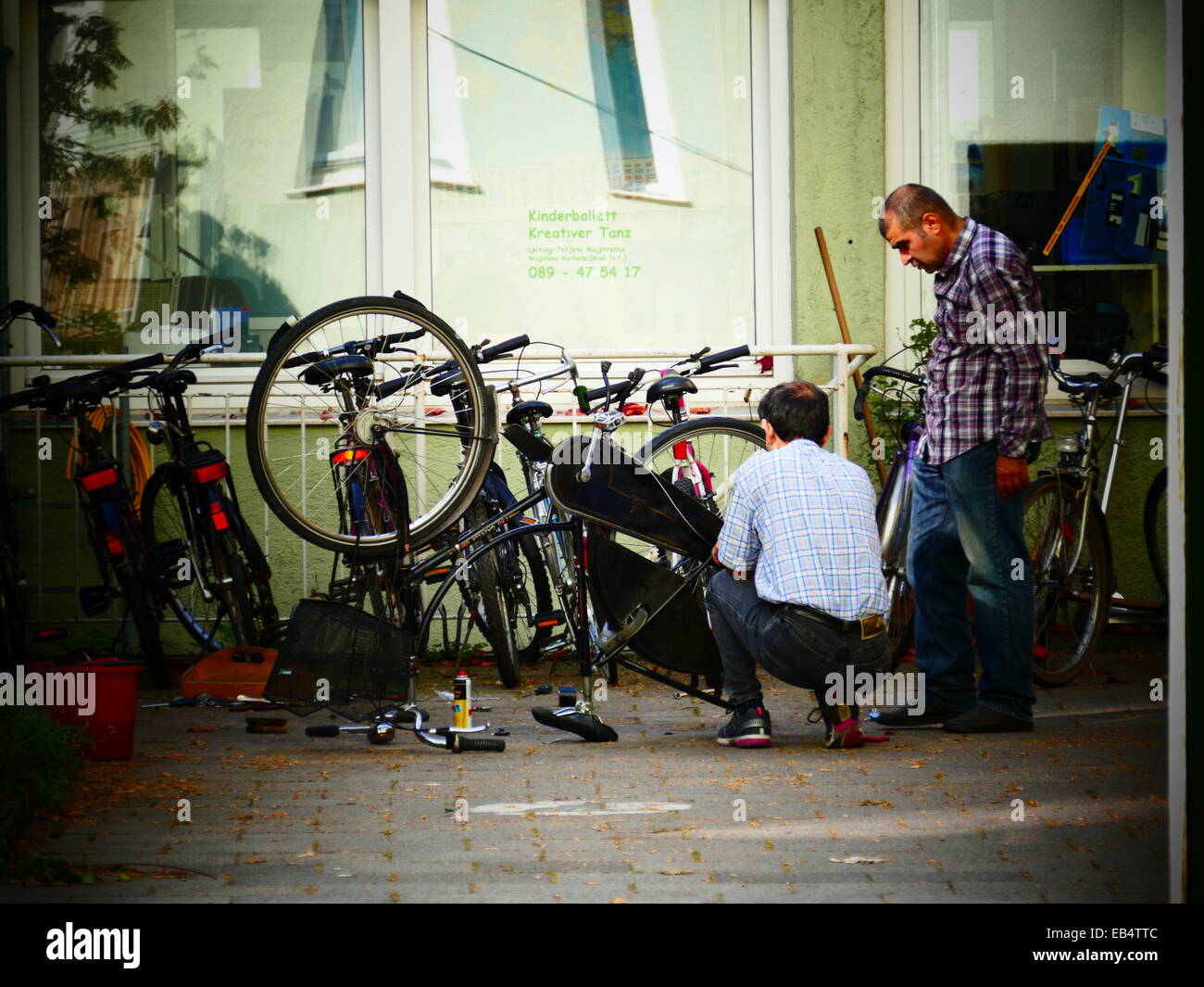 Man fixing bicycle wheel hi-res stock photography and images - Alamy