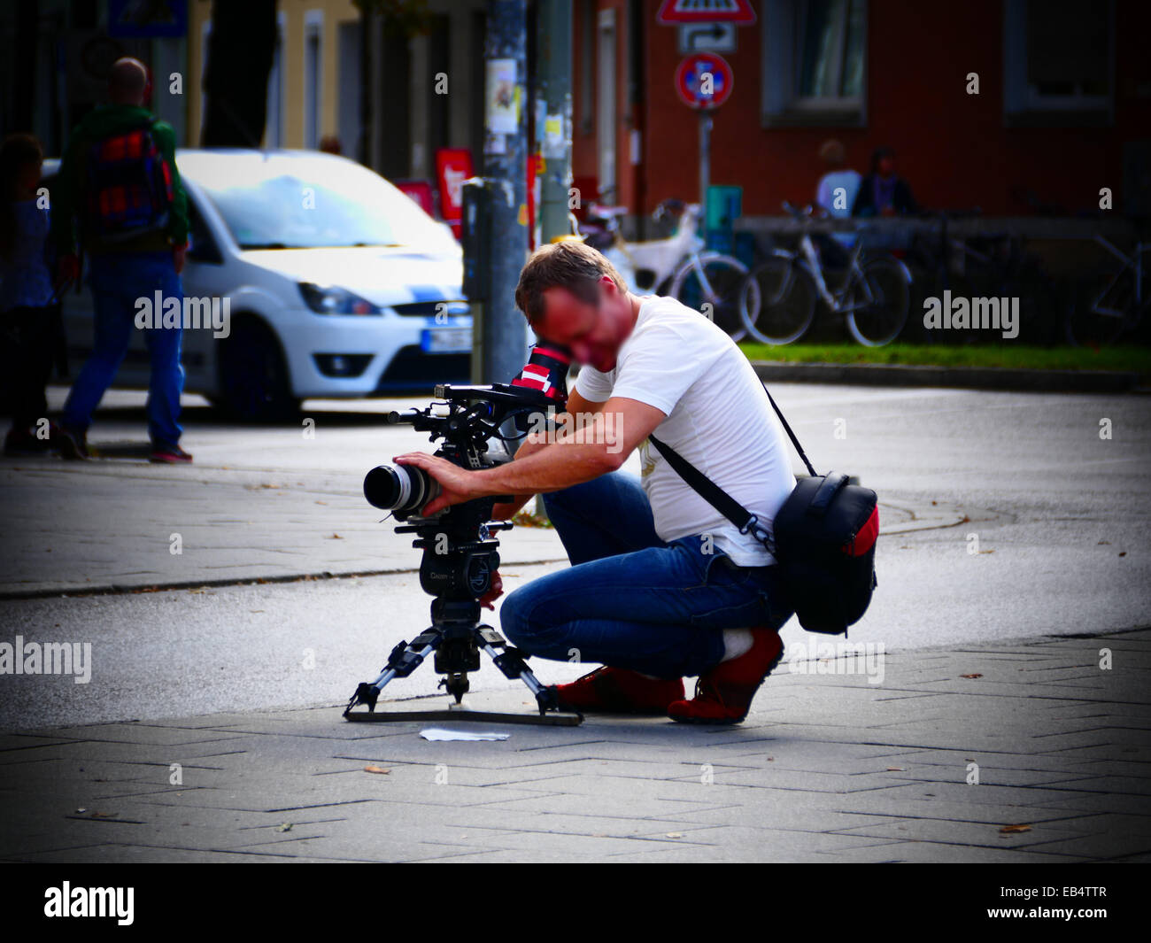 Cameraman shooting filming in the street Stock Photo - Alamy