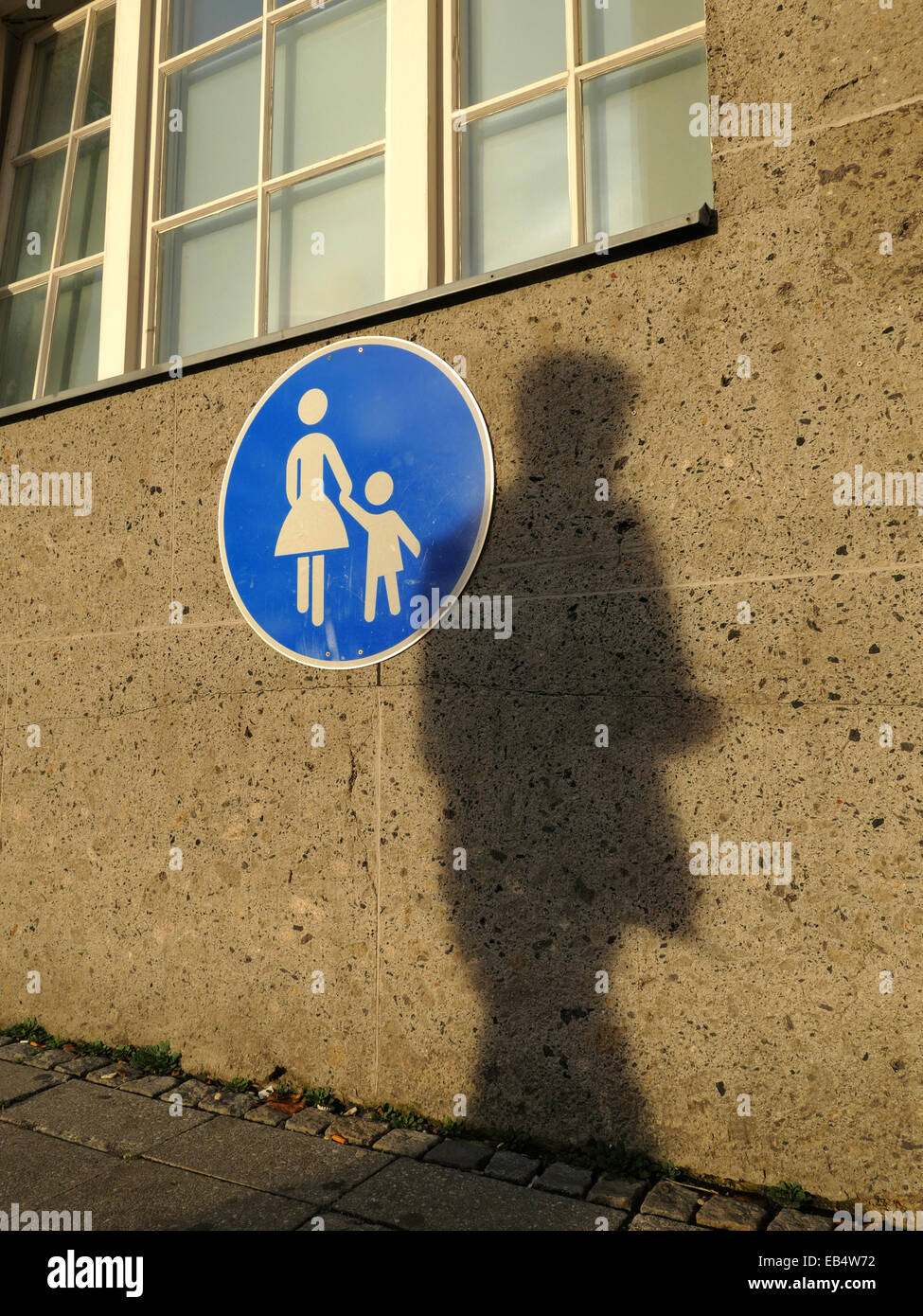 Anonymous abstract Man's shadow drop on Pedestrian sign Stock Photo - Alamy