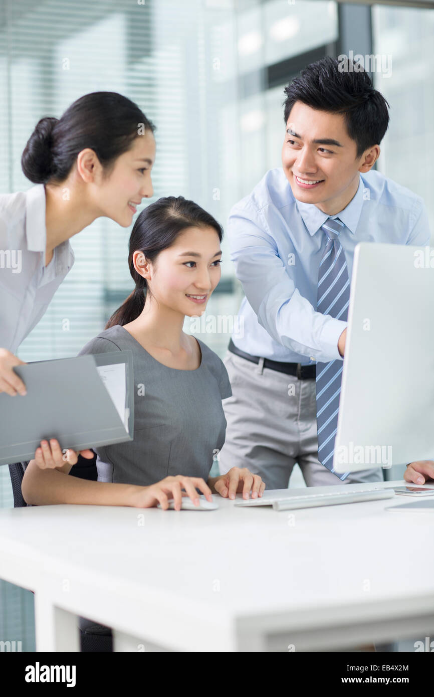 Young business people using computer in office Stock Photo - Alamy