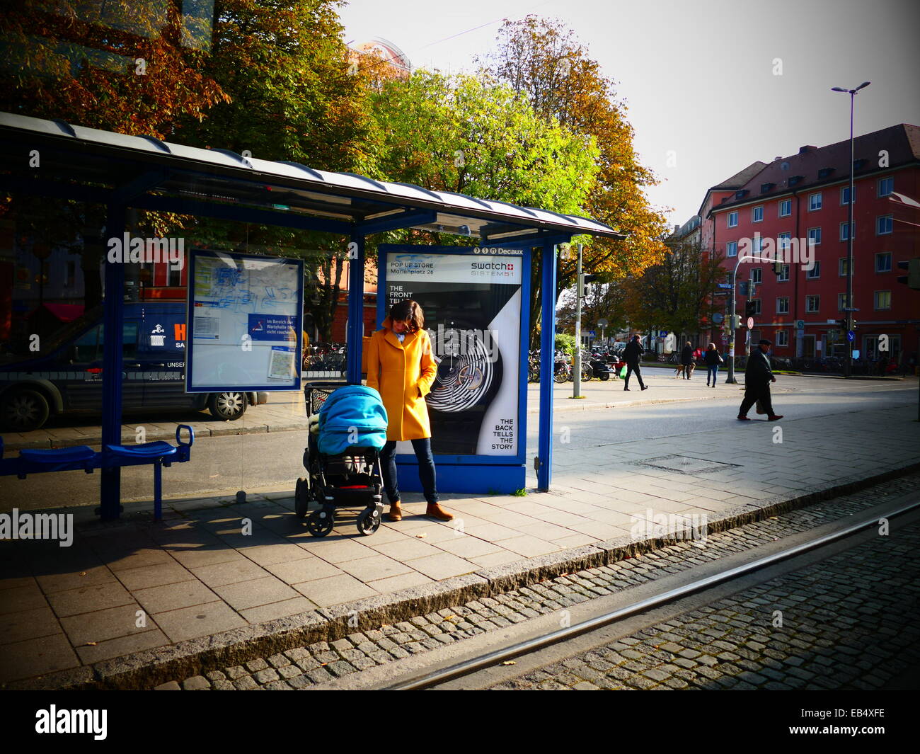 Happy Satisfy mother waiting Tram looking at baby in Kinderwagon ...
