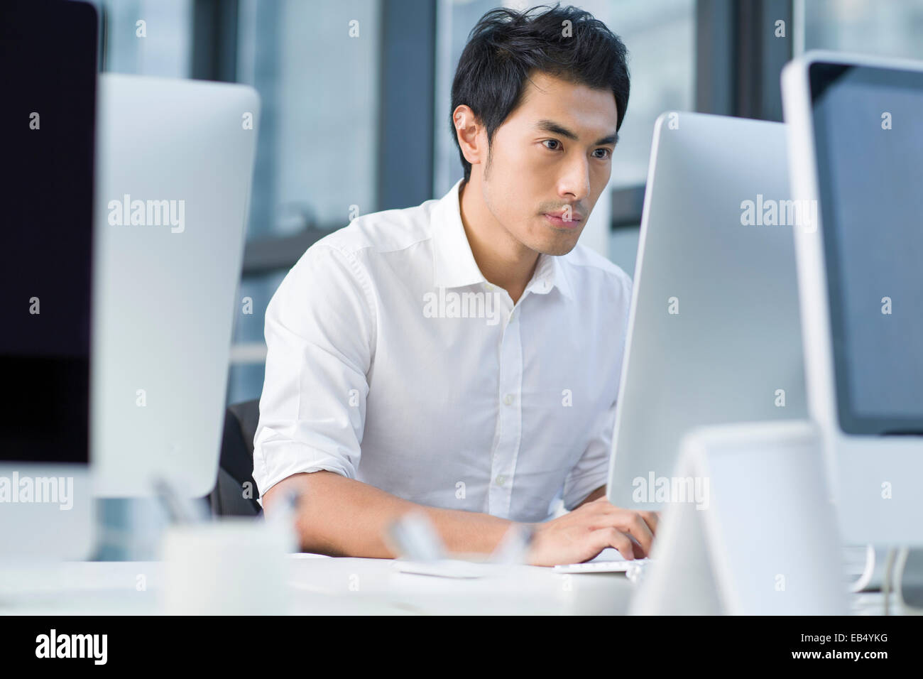 Young businessman using computer in office Stock Photo - Alamy