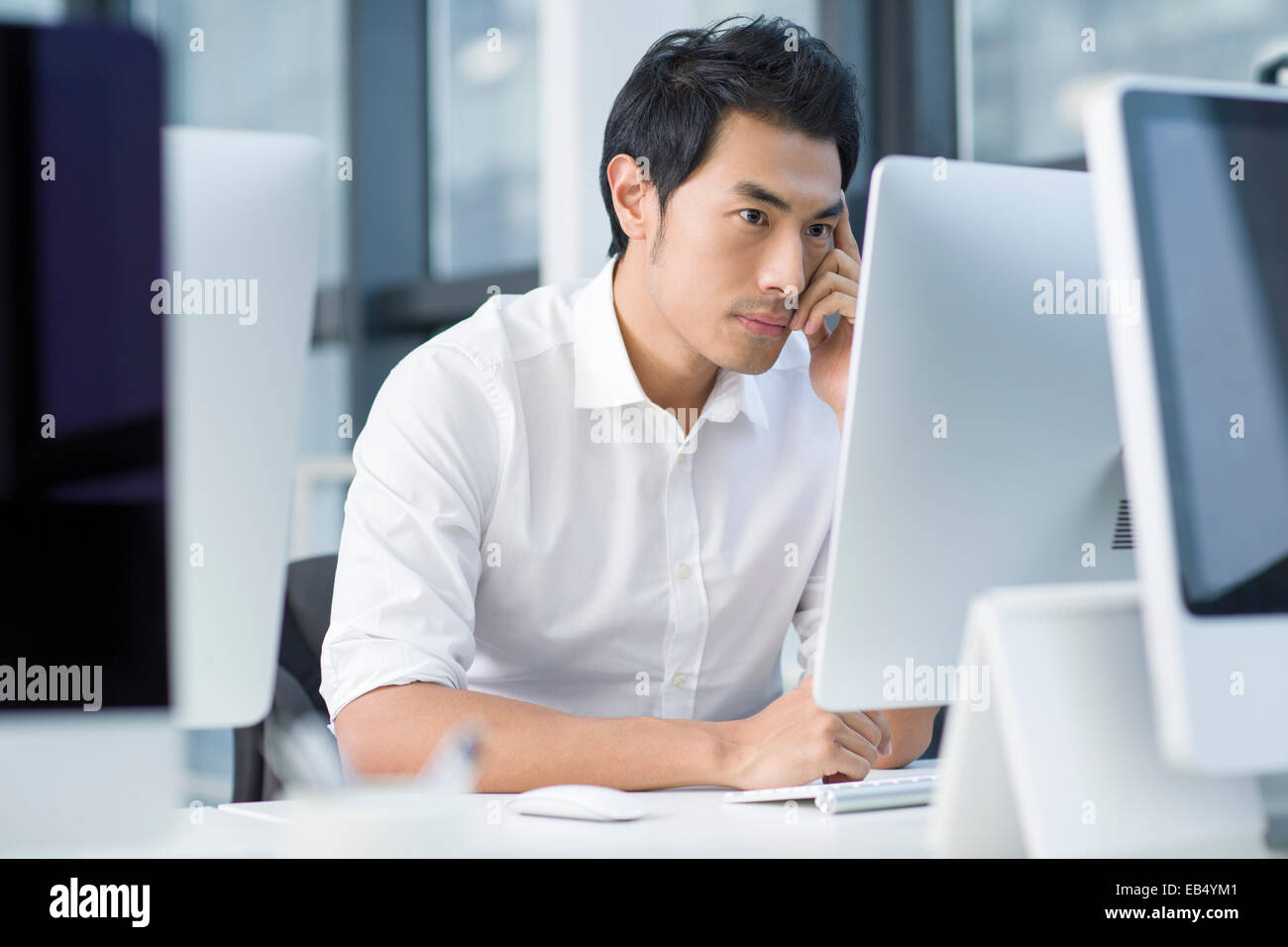 Young businessman using computer in office Stock Photo - Alamy
