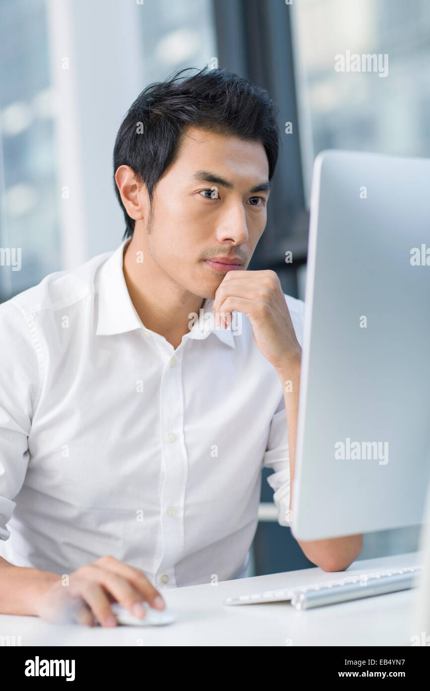 Young businessman using computer in office Stock Photo - Alamy