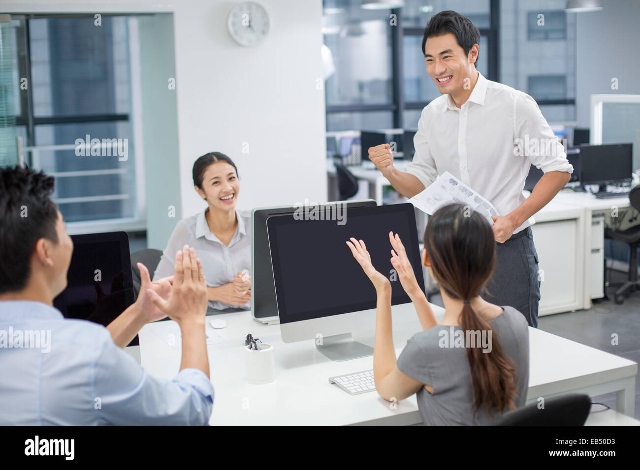 Young business people cheering in office Stock Photo - Alamy