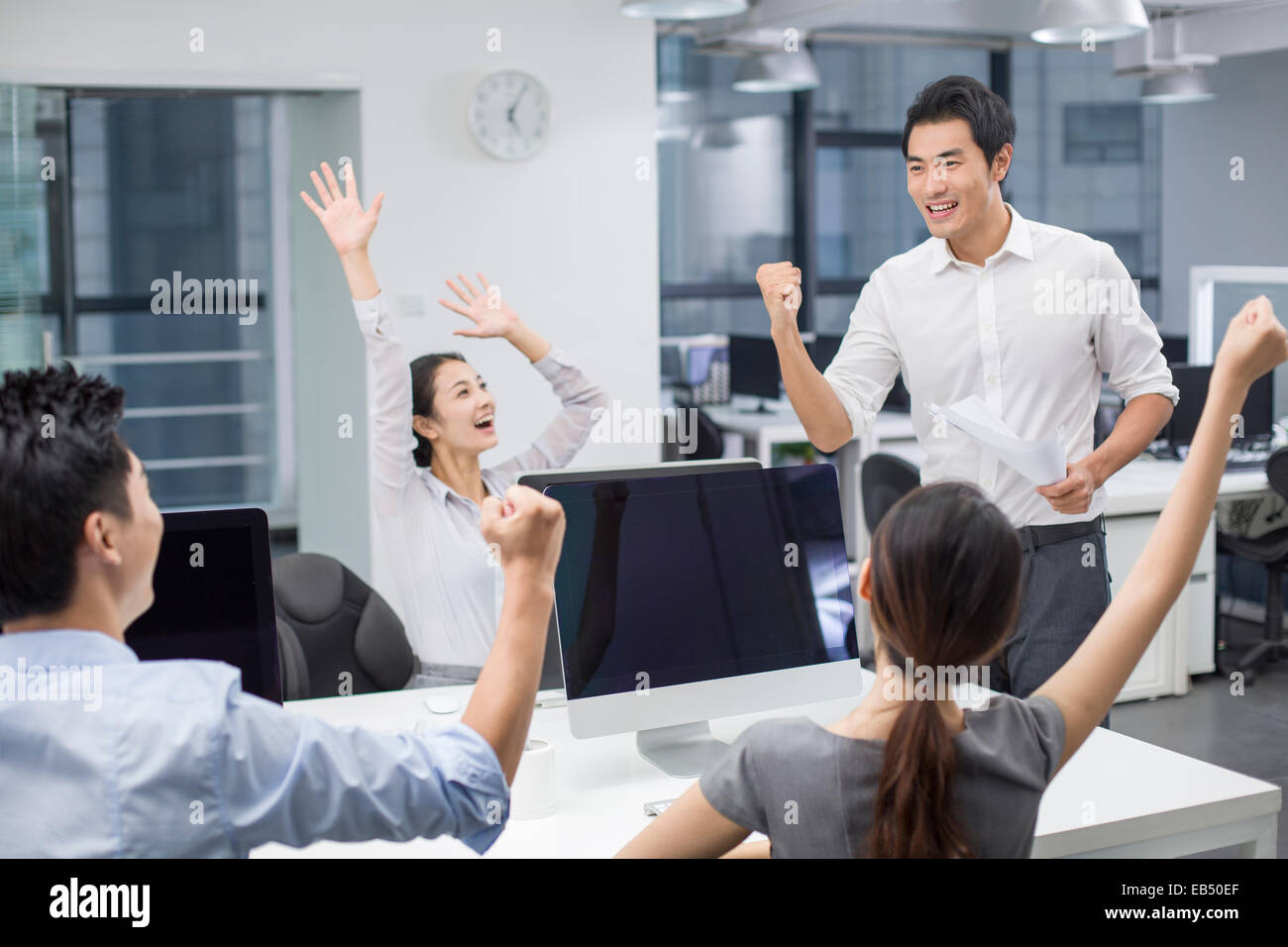 Young business people cheering in office Stock Photo - Alamy