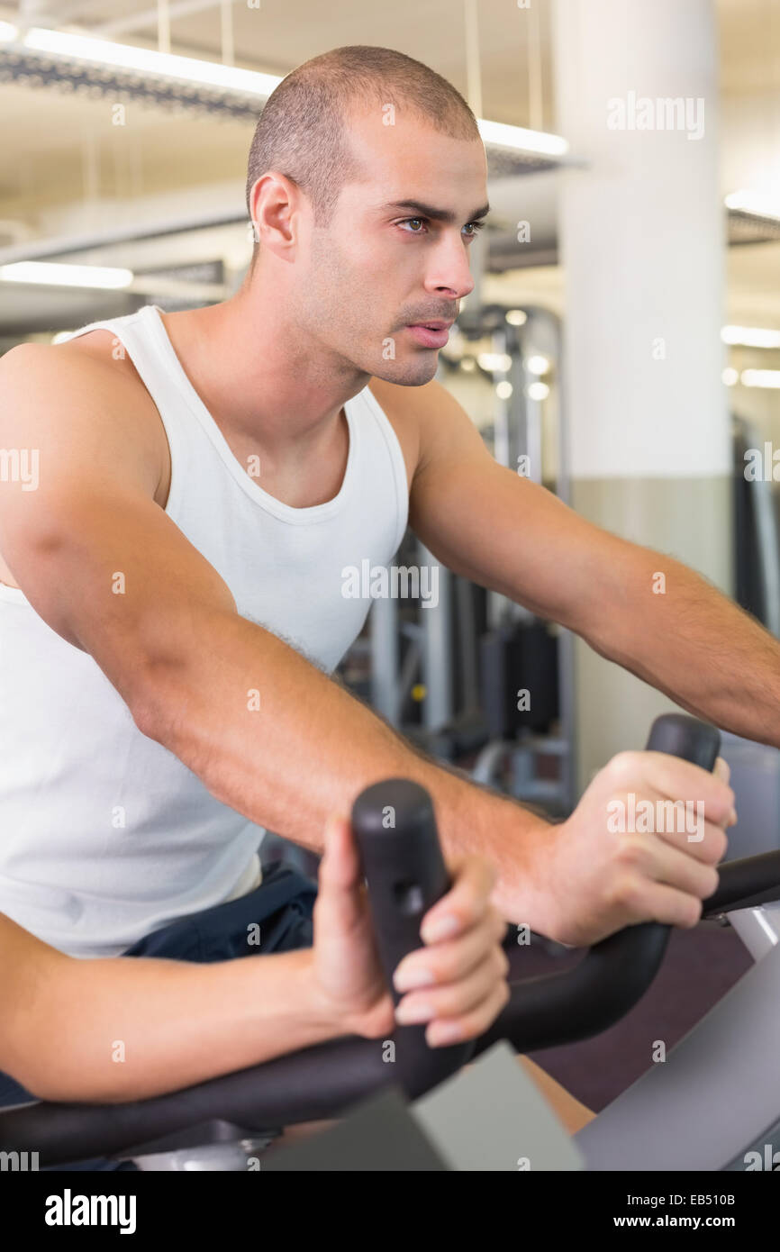 Man working out on exercise bike at gym Stock Photo - Alamy
