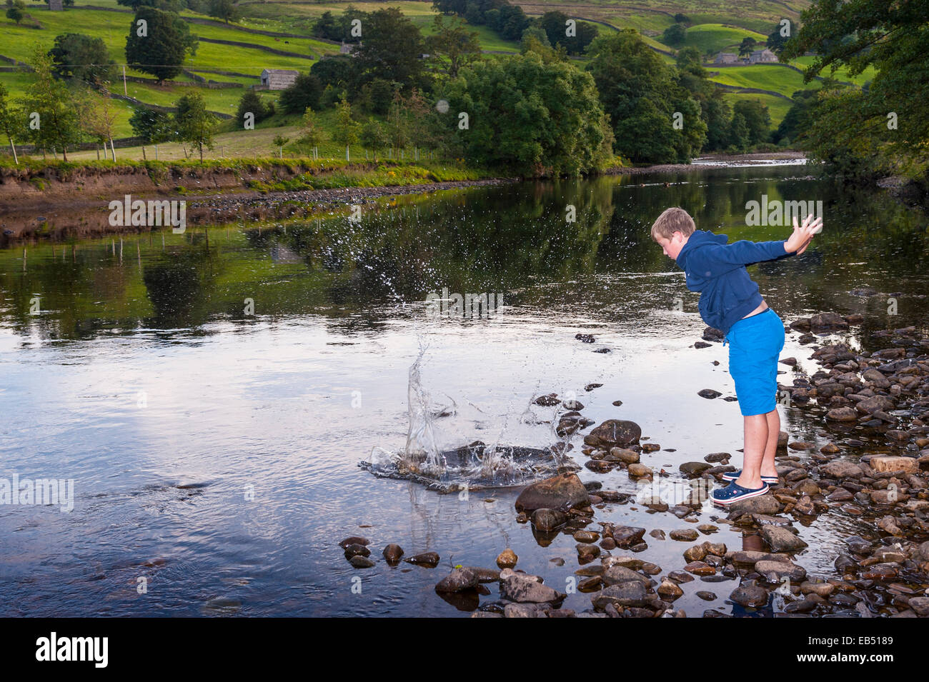 A Child playing at the river Swale at Swaledale in the Yorkshire Dales ...