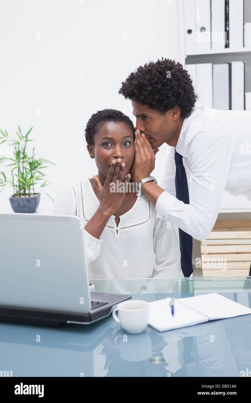 Man telling a business secret at his colleague Stock Photo - Alamy