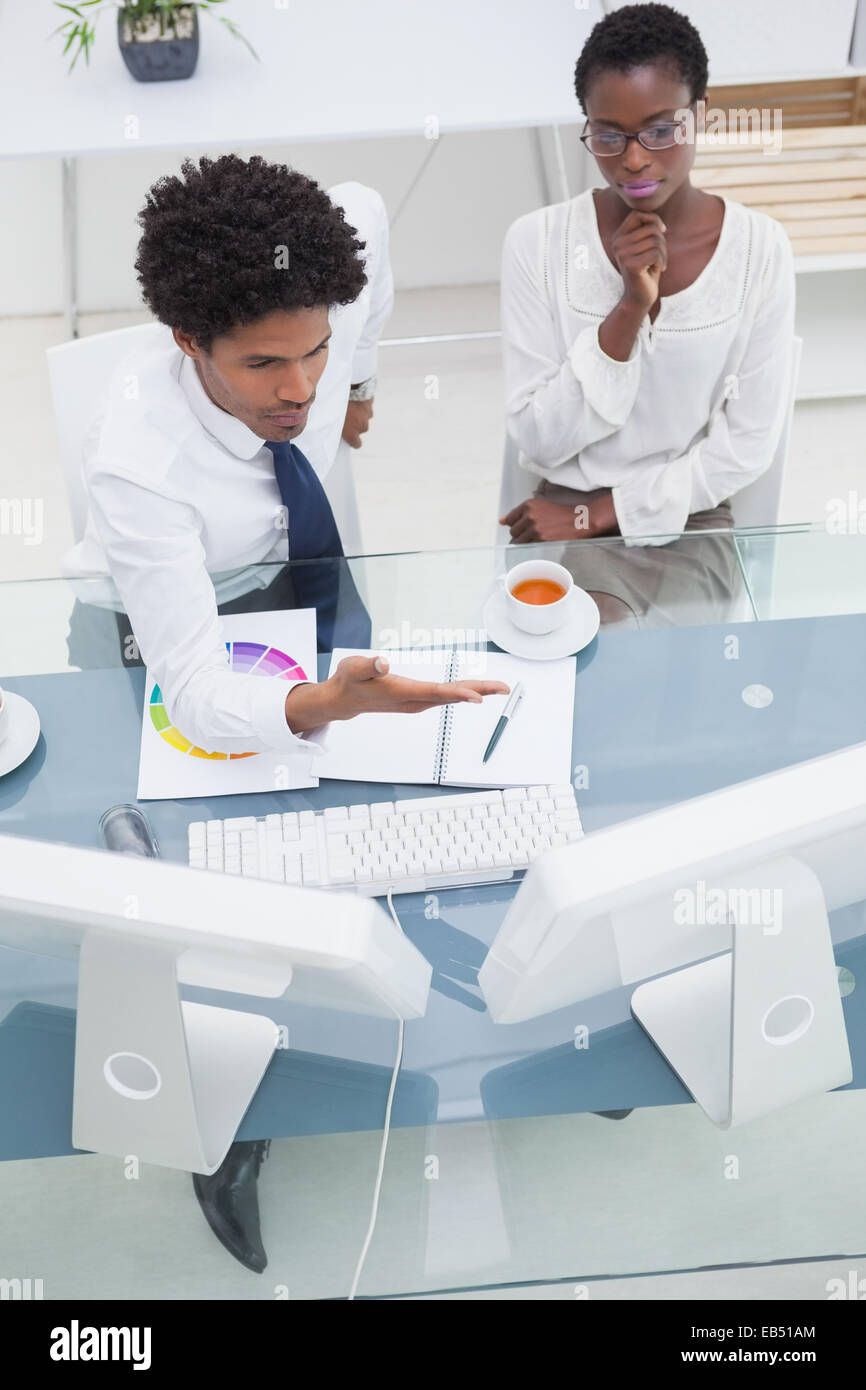 Team using computer and thinking Stock Photo - Alamy