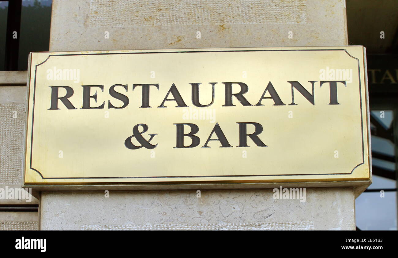 Golden restaurant and bar sign in the street Stock Photo - Alamy