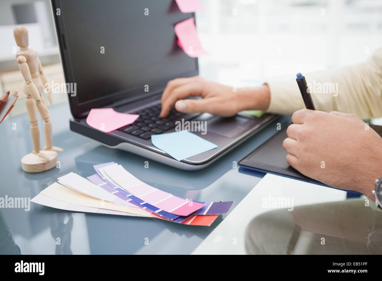 Designer using laptop and digitizer Stock Photo - Alamy
