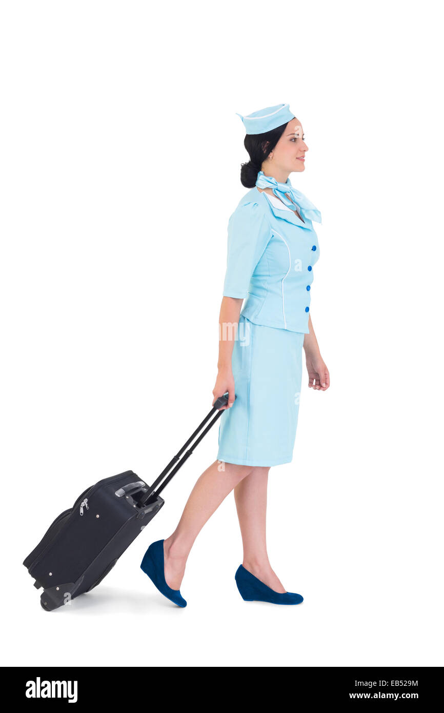 Pretty air hostess walking with suitcase Stock Photo - Alamy