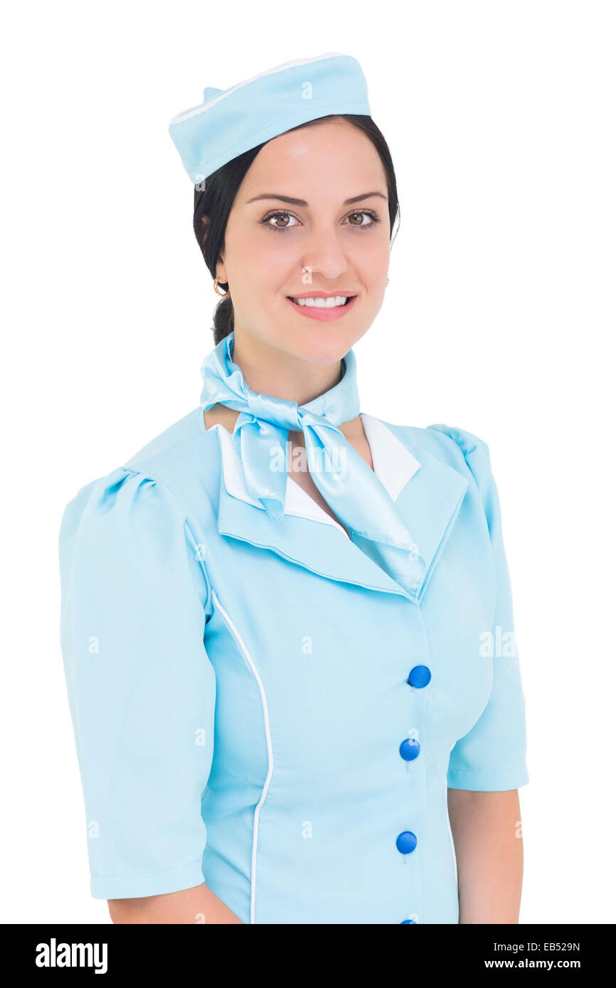 Pretty air hostess smiling at camera Stock Photo - Alamy