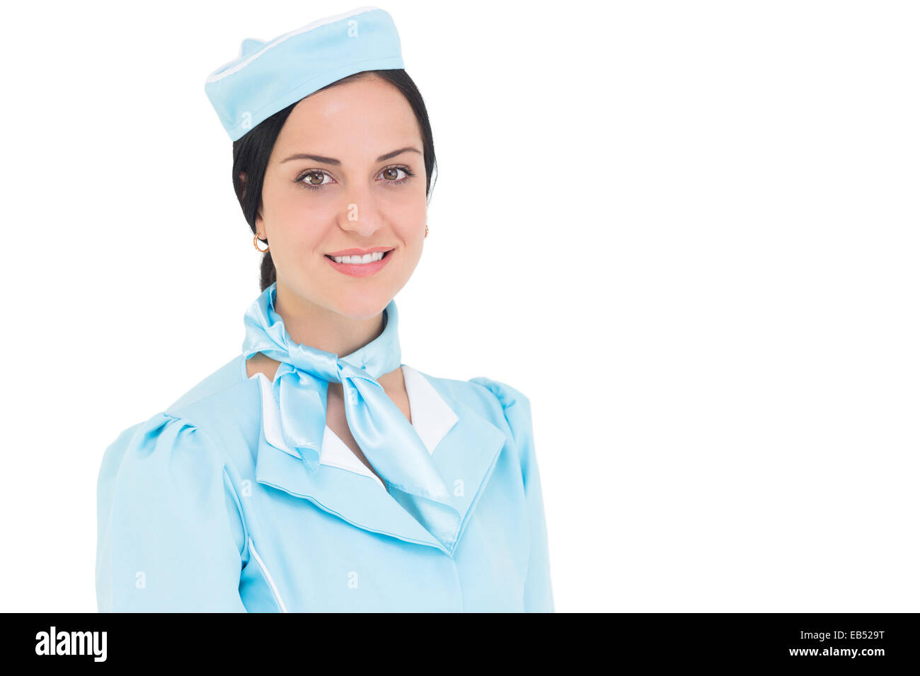 Pretty air hostess smiling at camera Stock Photo - Alamy