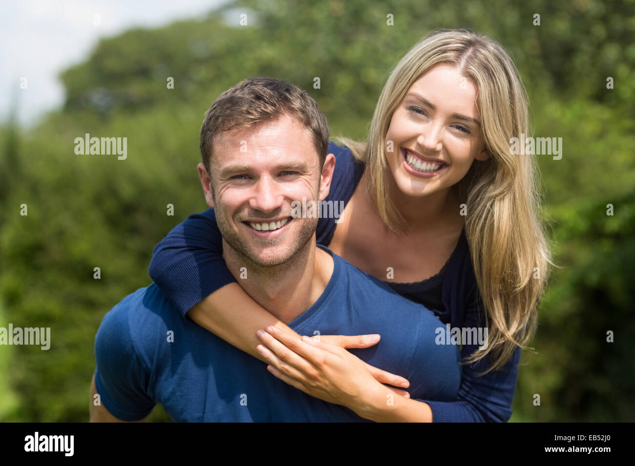 Cute couple smiling at camera Stock Photo - Alamy