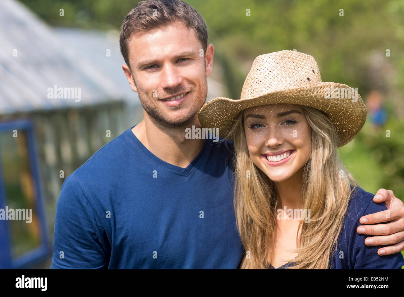Cute couple smiling at camera Stock Photo - Alamy