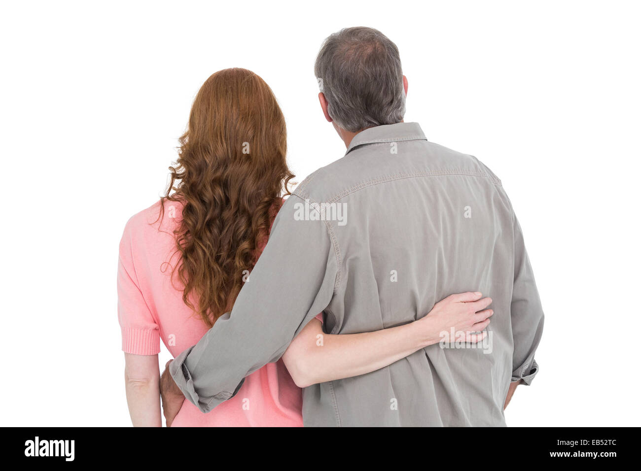 Casual couple standing arm around Stock Photo - Alamy