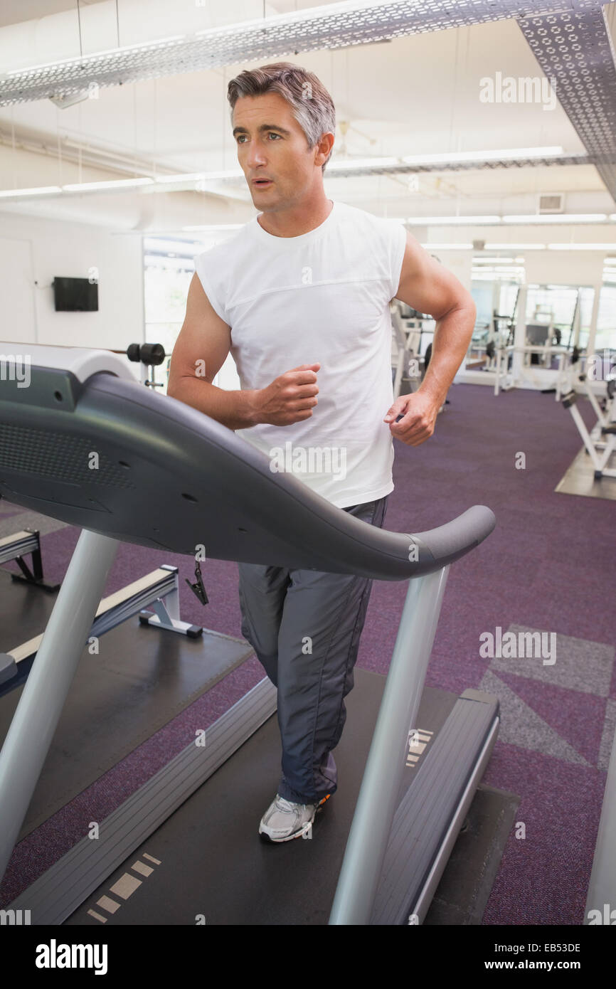 Fit man working out on treadmill Stock Photo - Alamy