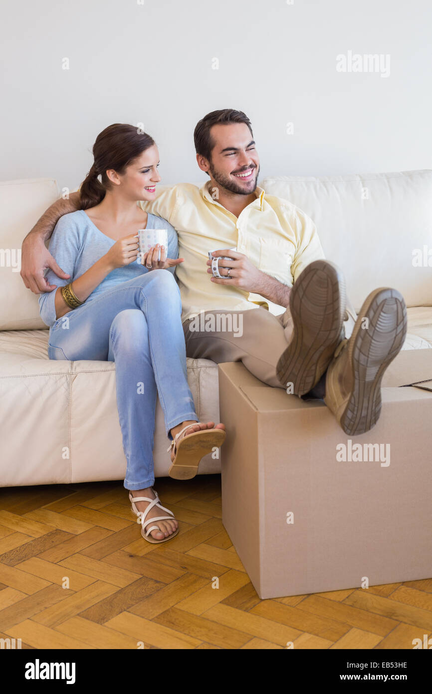 Young couple taking a break from unpacking Stock Photo - Alamy