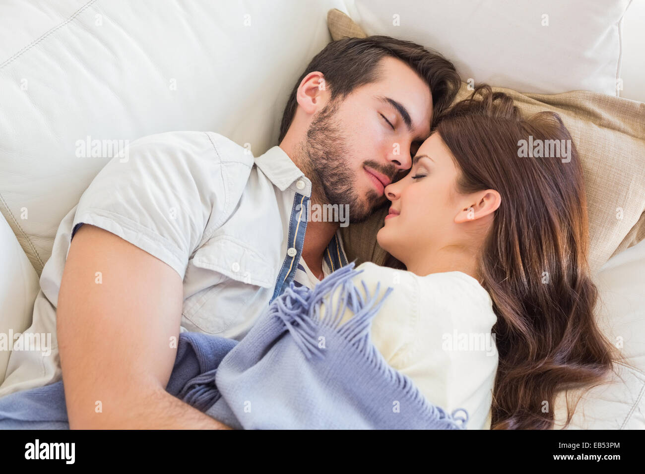Cute couple napping on couch Stock Photo - Alamy
